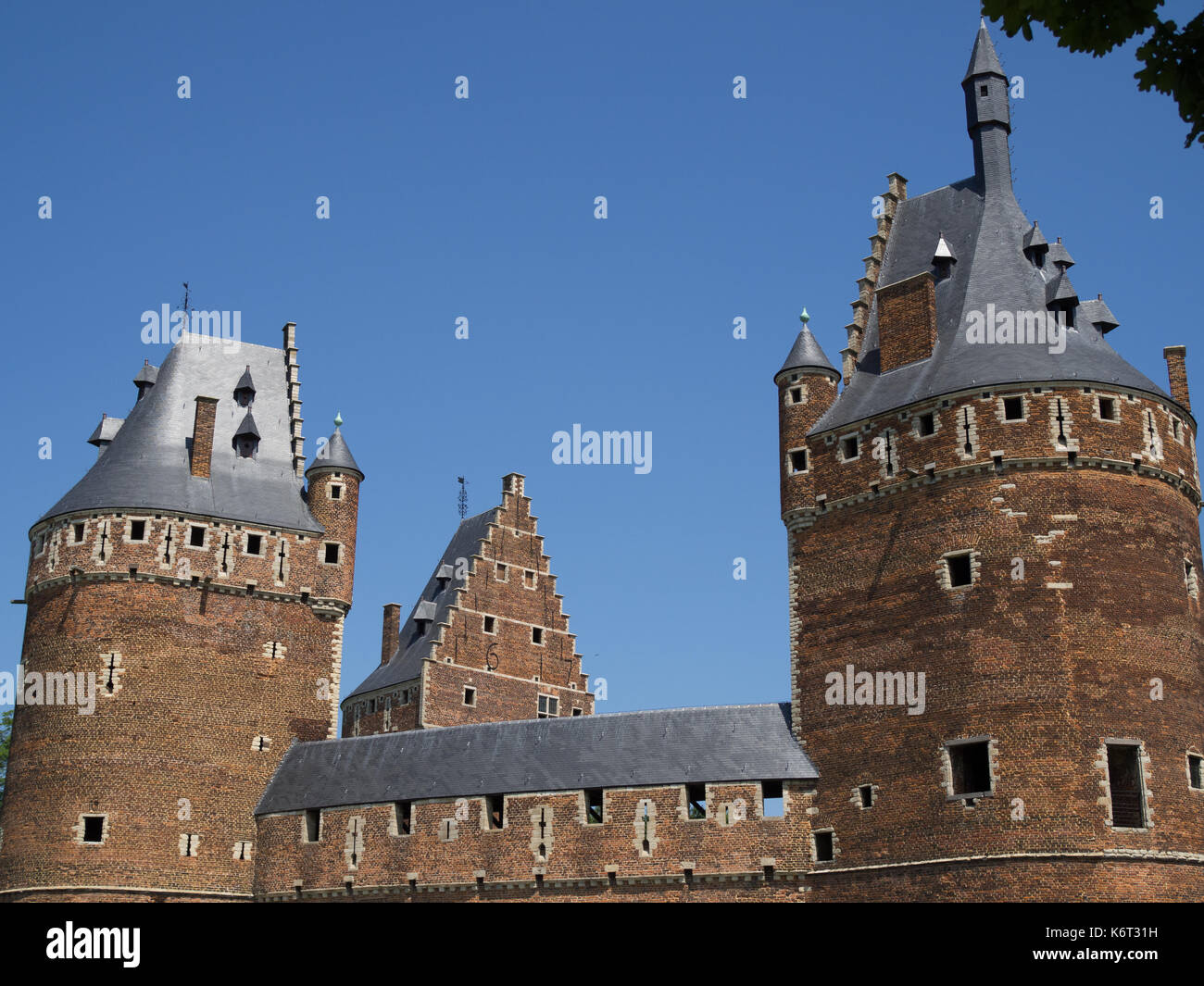 A close up of the facades and towers of a medieval castle in Beersel ...
