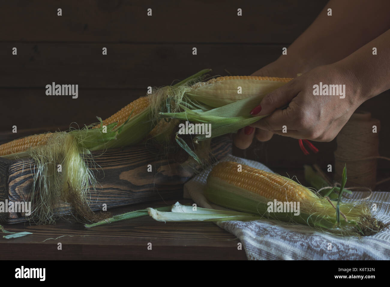 Fresh sweet corn on cobs on rustic wooden table, close up. Toned ...