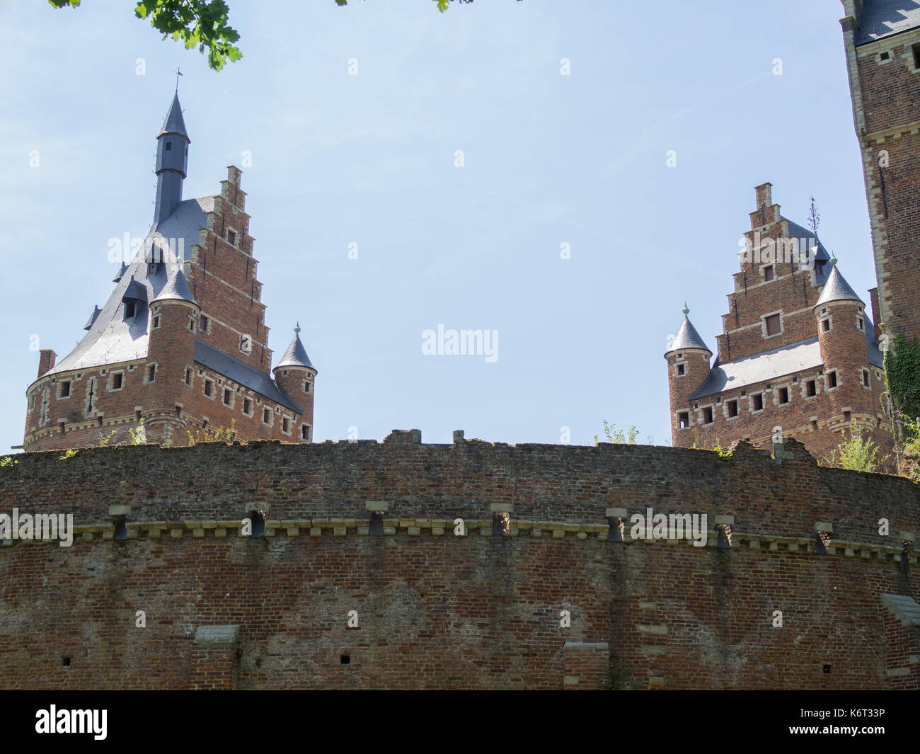 A close up of the facades and towers of a medieval castle in Beersel ...