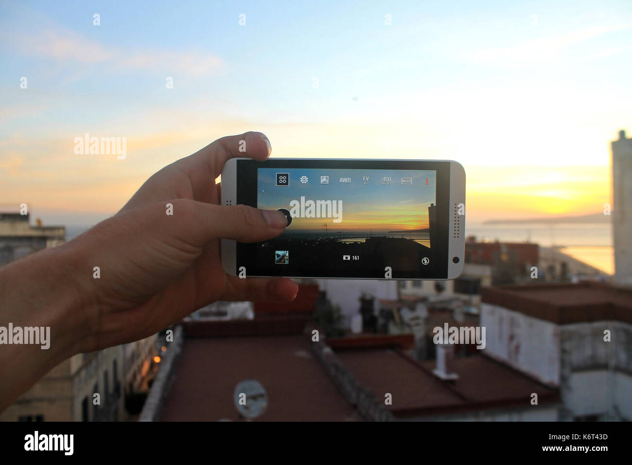 Human hand taking photo of sunrise hi-res stock photography and images ...