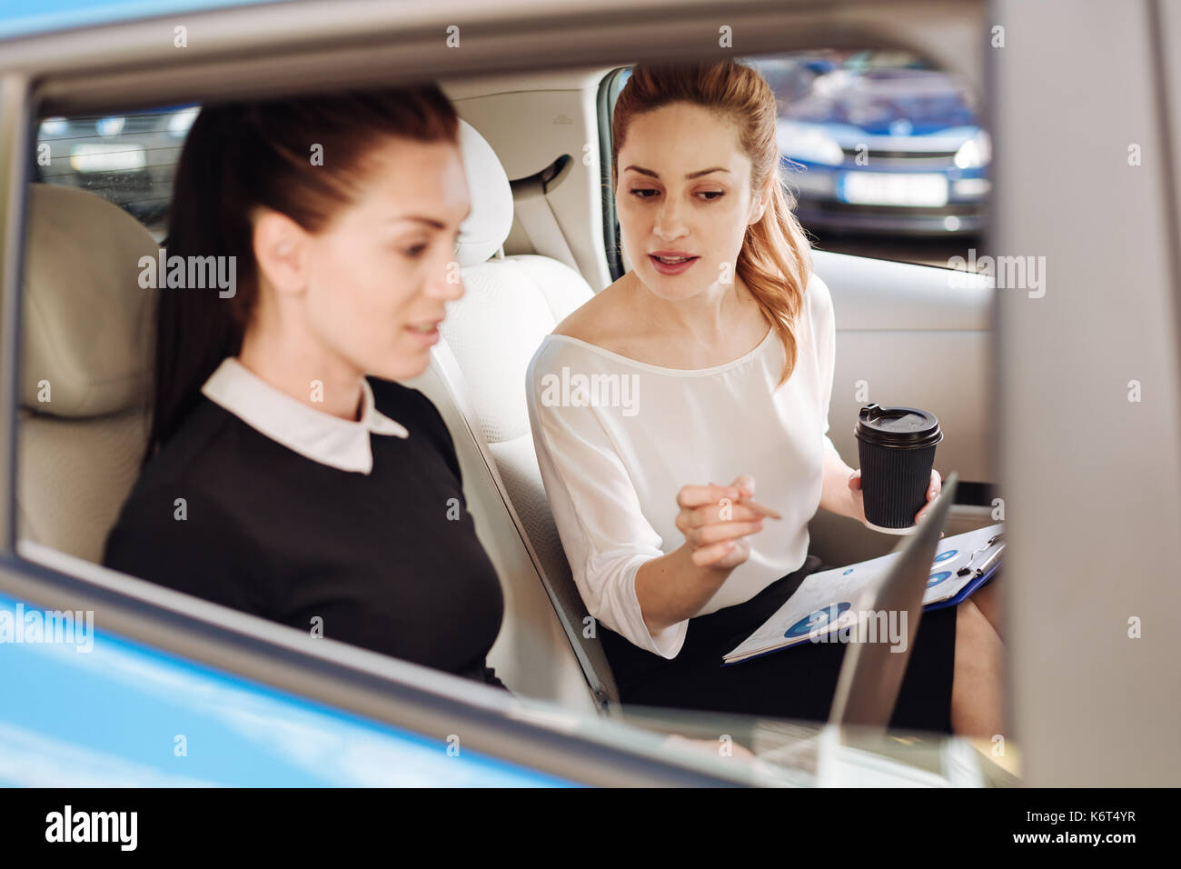 Smart professional businesswomen working in the car Stock Photo - Alamy