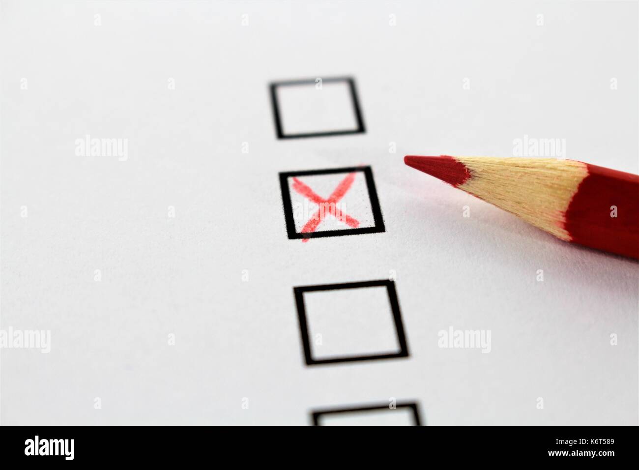 An concept Image of a red pencil and a questionnaire Stock Photo - Alamy