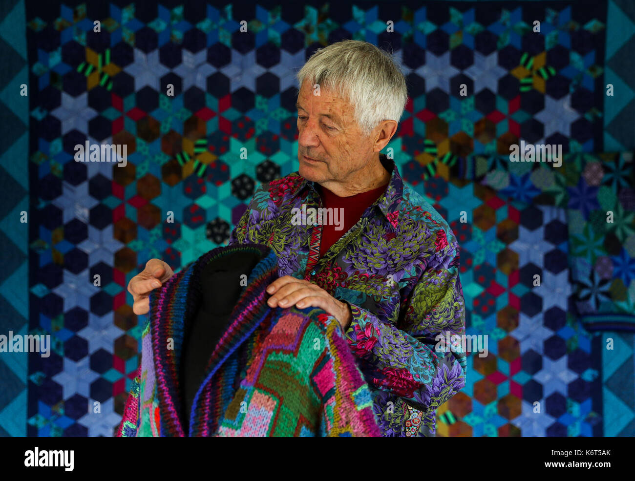 Textile artist Kaffe Fassett looks at one of his knitted coats on ...