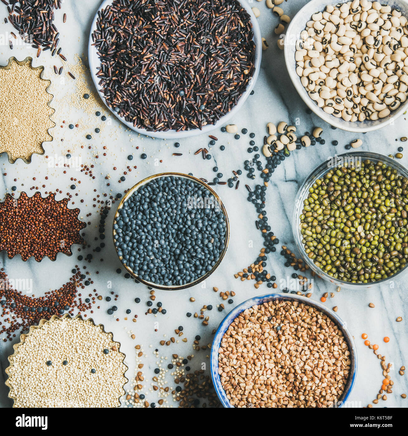 Variety of raw grains, beans, cereals, marble background, square crop ...
