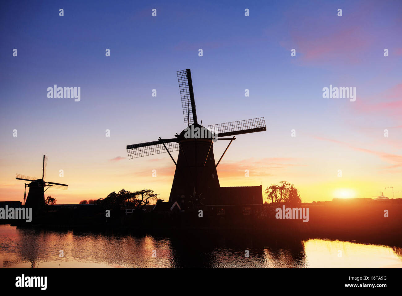 Landscape with beautiful traditional Dutch mill near water courses in ...