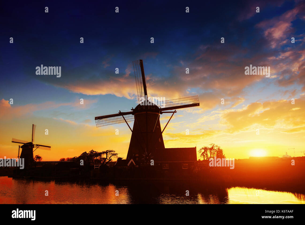 Landscape with beautiful traditional Dutch mill near water courses in ...