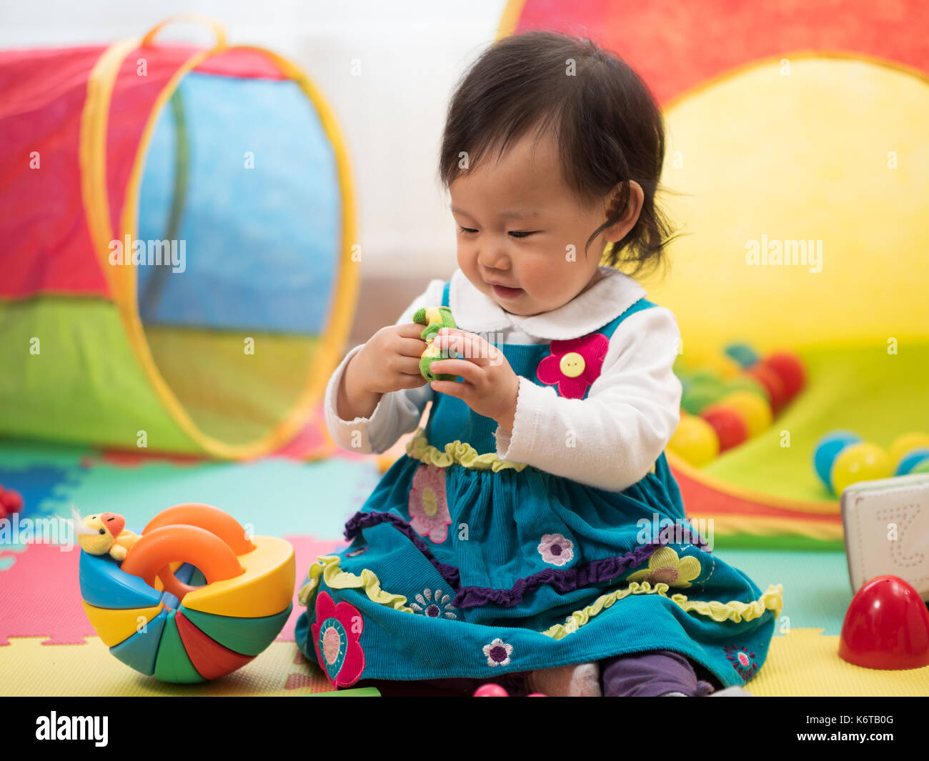 baby girl playing puppet at home Stock Photo - Alamy