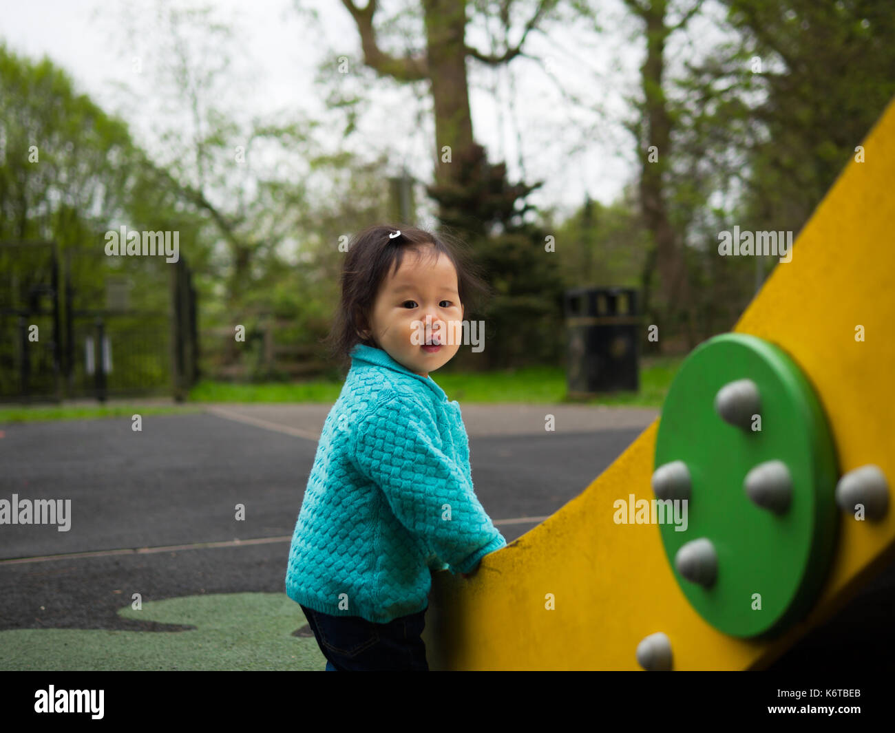 baby girl playing in the playground Stock Photo - Alamy