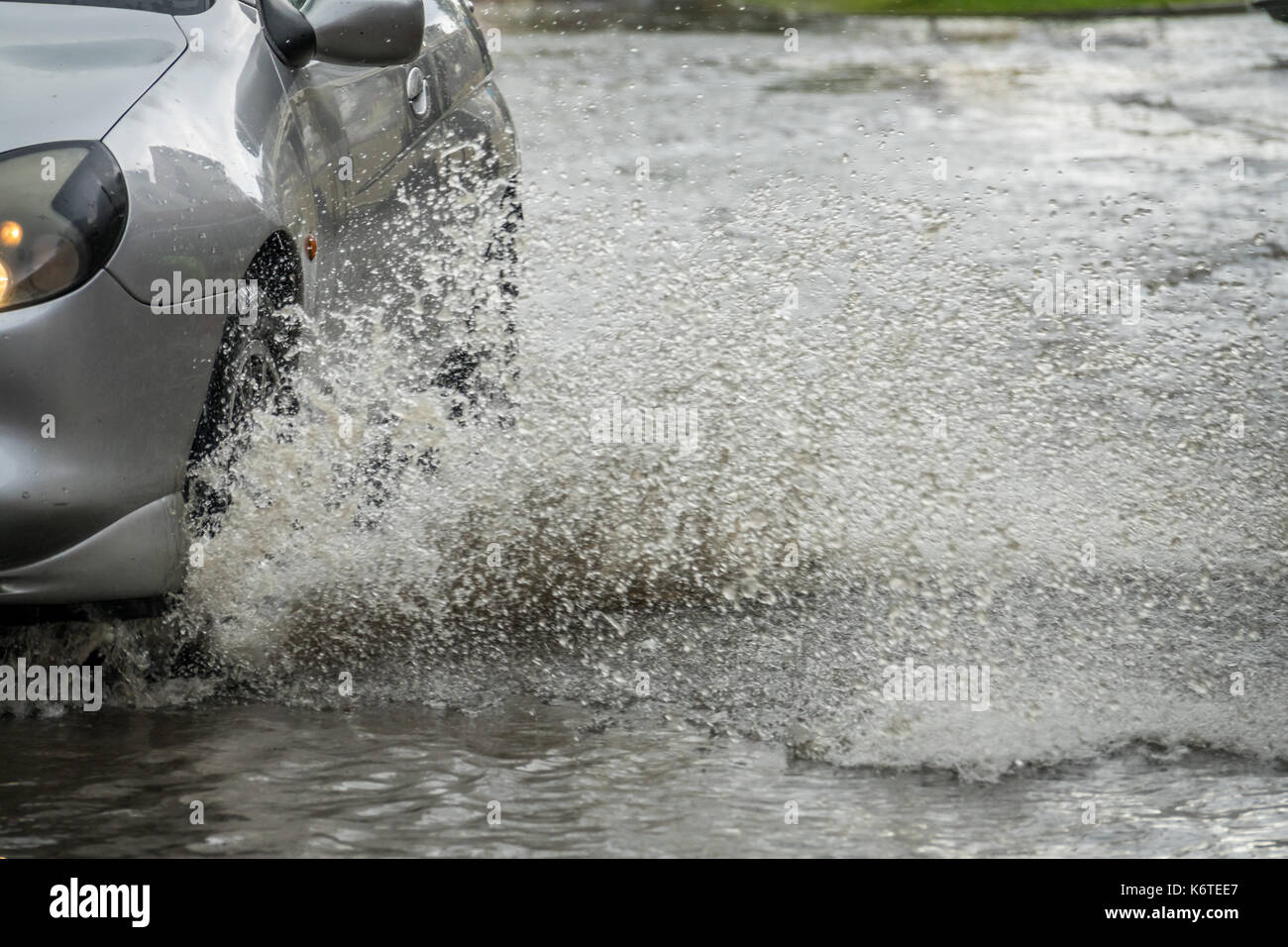 Sarbinowo, Poland - August 2017 : Car going through the flooded street ...
