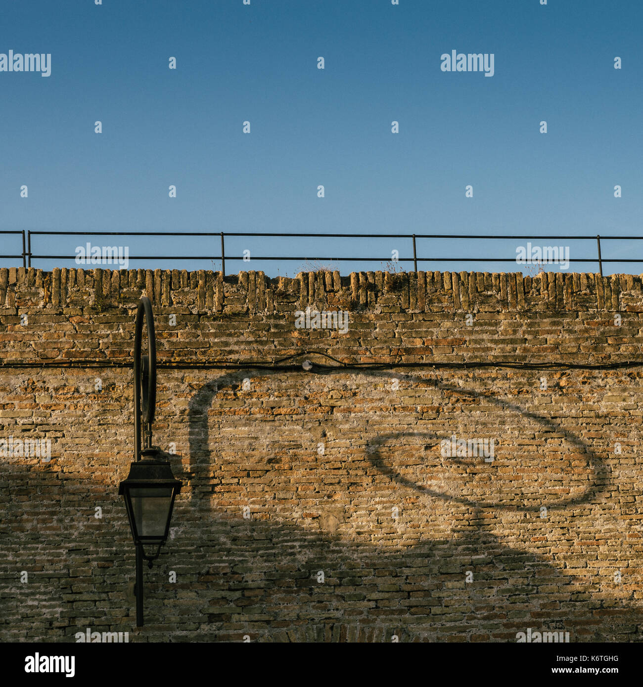 Lamp post shadow against the wall and blue sky Stock Photo - Alamy