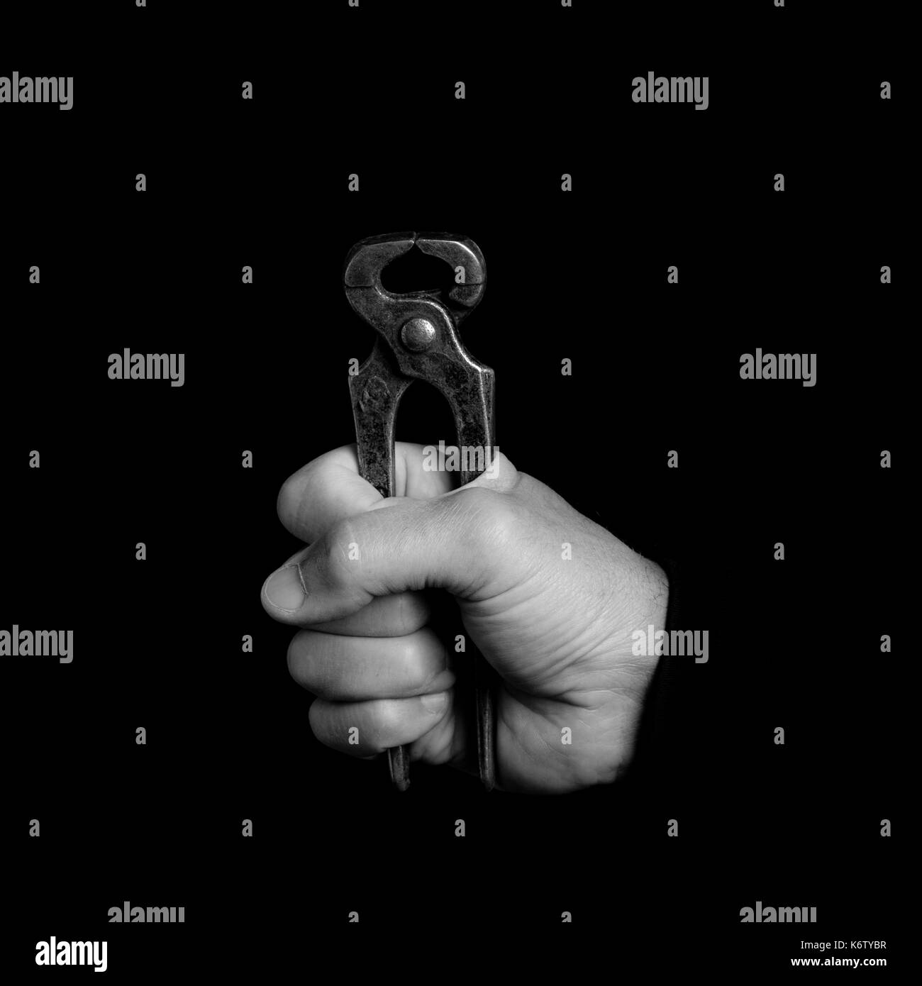 pincer - tools in a man's hand - black and white photo Stock Photo - Alamy