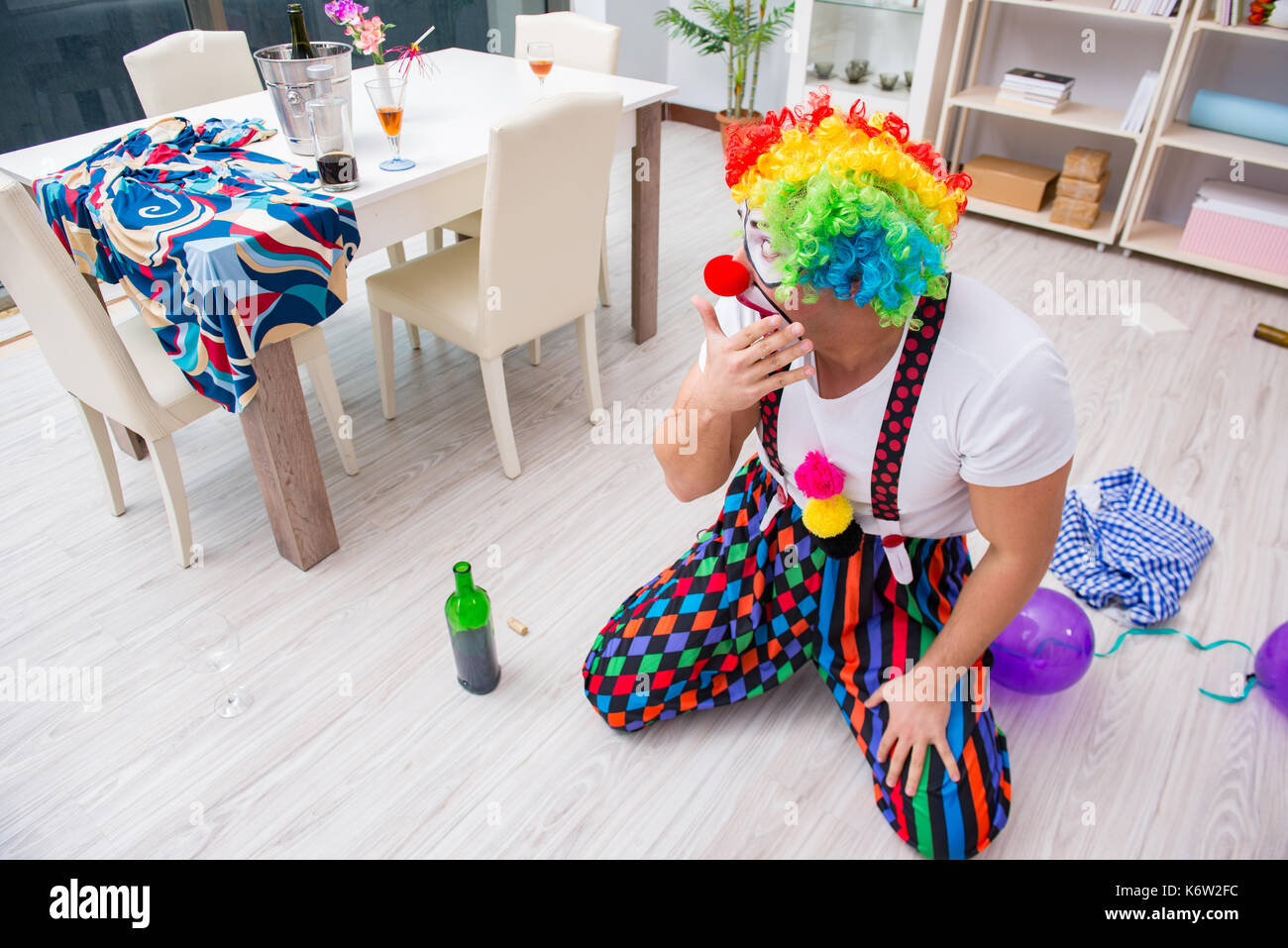 Drunk clown celebrating having a party at home Stock Photo - Alamy