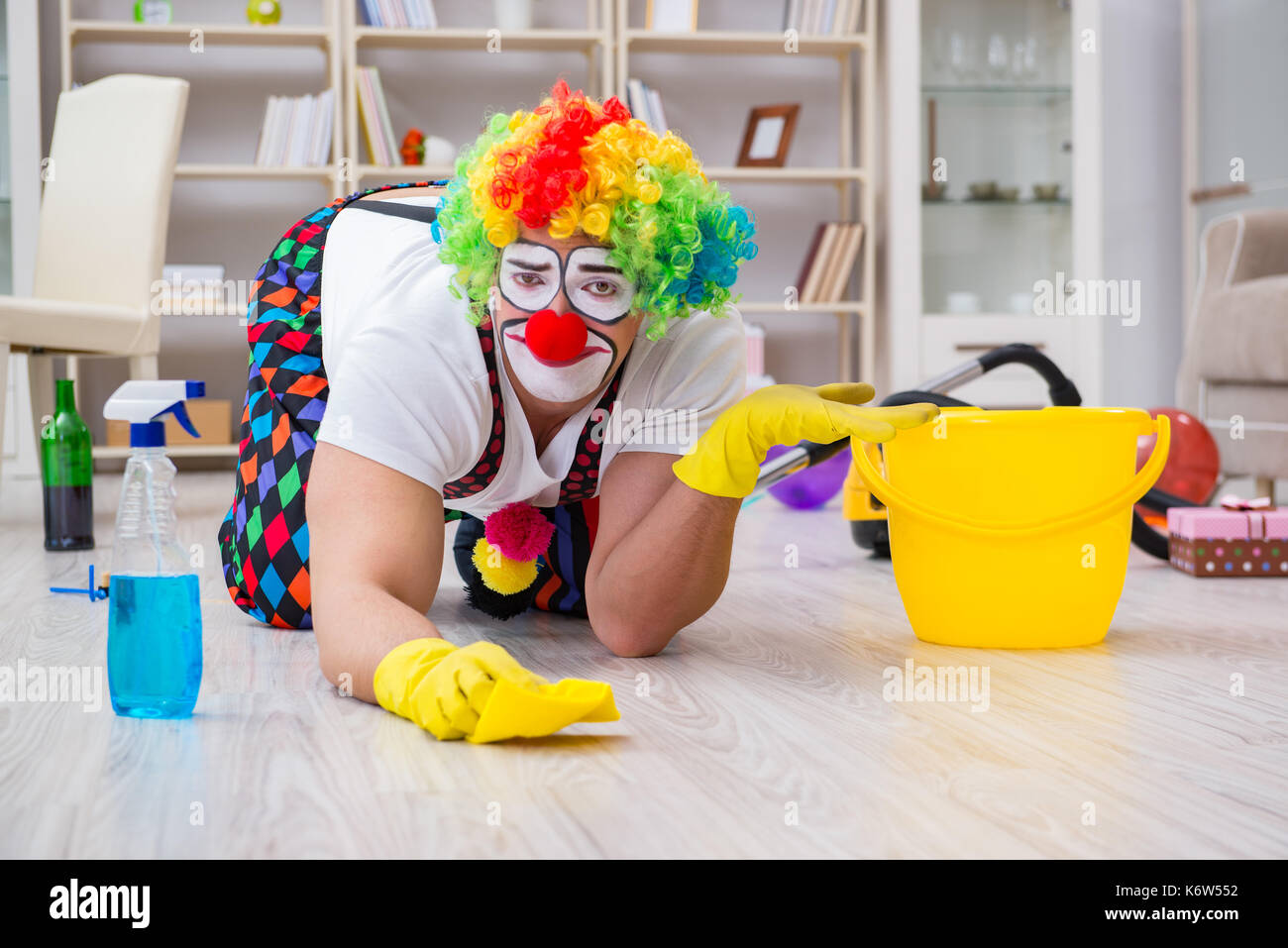 Funny clown doing cleaning at home Stock Photo - Alamy