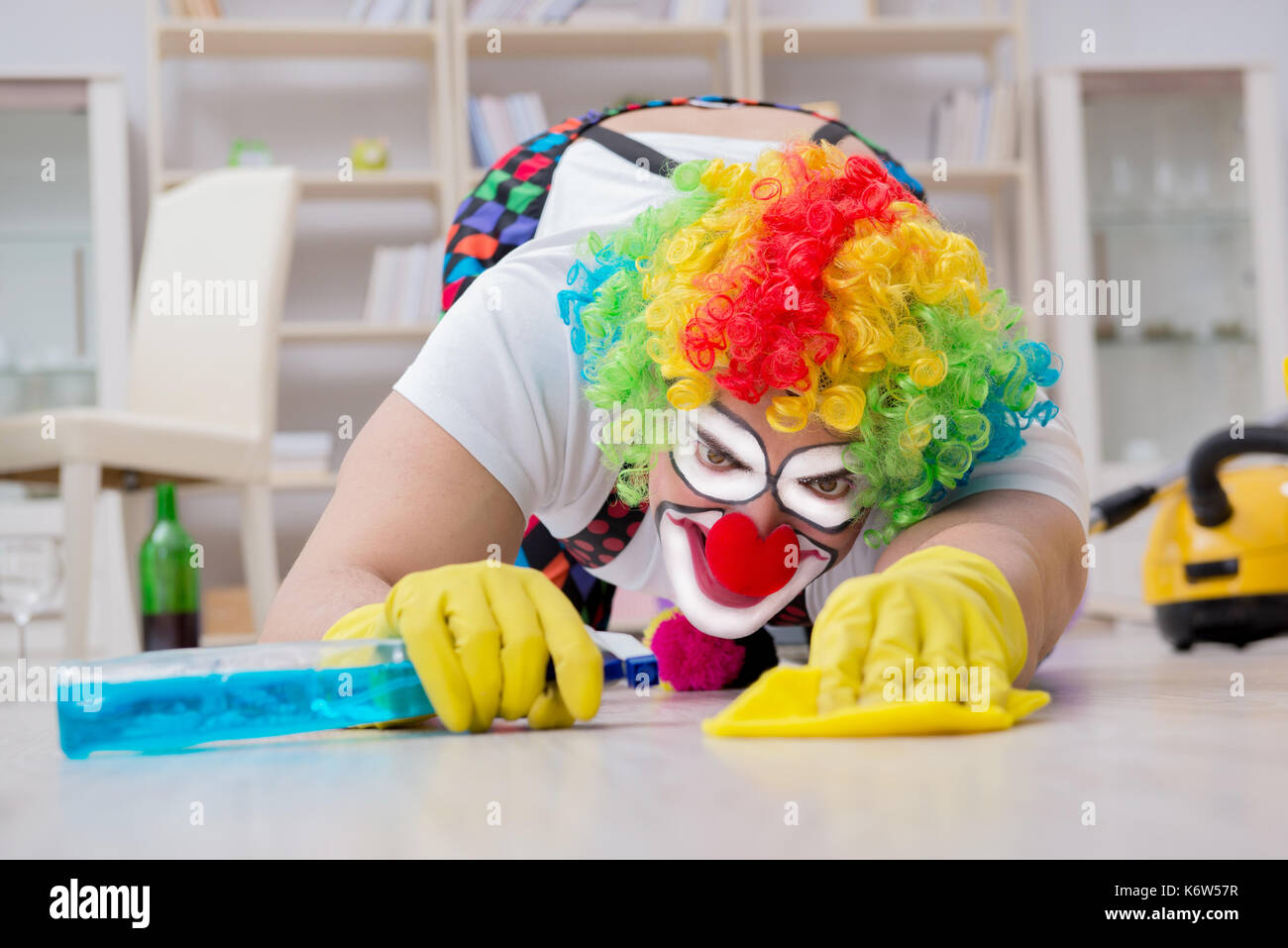 Funny clown doing cleaning at home Stock Photo - Alamy