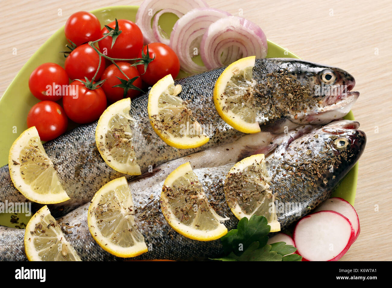 prepared trout fish with lemon and vegetables Stock Photo - Alamy