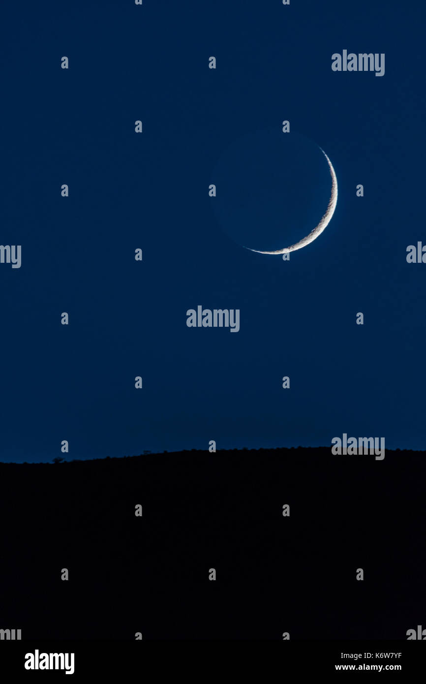 Waxing Crescent Moon Over Mountain Ridge in dark zone Stock Photo - Alamy