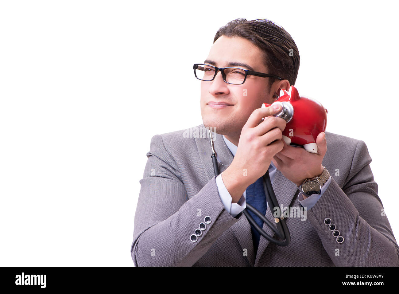 Businessman with stethoscope and piggybank isolated withe background ...