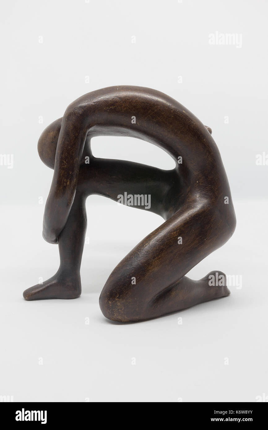 Wooden sculpture of man crouched, isolated on white background Stock ...