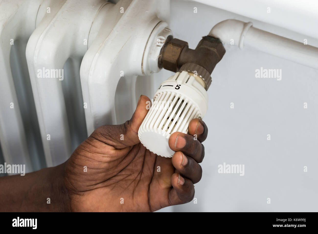Close-up Of Person Hands Adjusting Thermostat Radiator Valve Stock ...