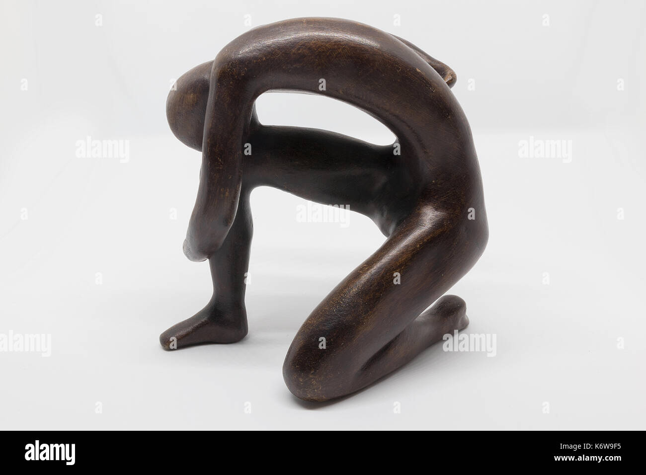 Wooden sculpture of man crouched, isolated on white background Stock ...