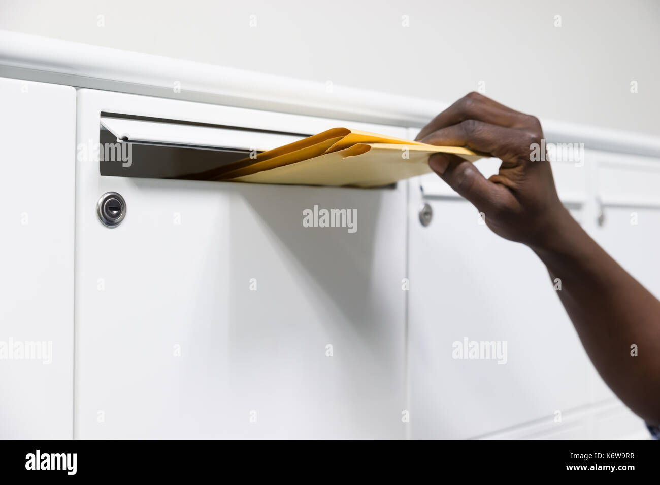 Black hand holding envelope hi-res stock photography and images - Alamy