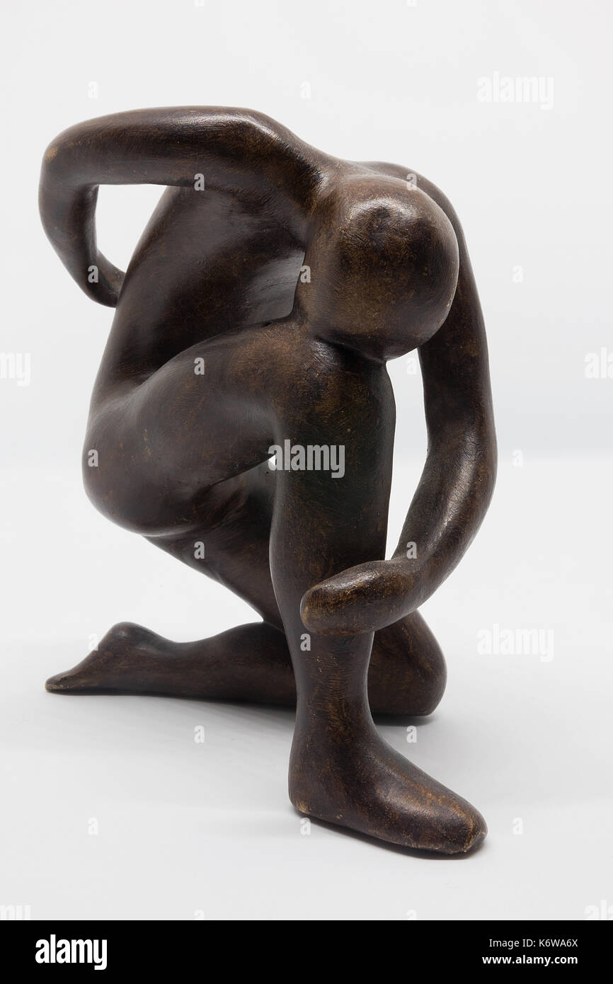 Wooden sculpture of man crouched, isolated on white background Stock ...