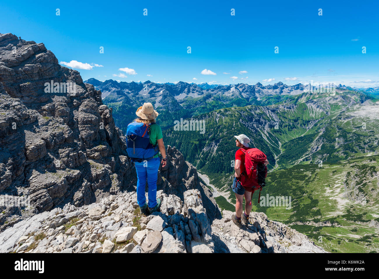 Two hikers with views of the mountains and Alps, Hiking trail to the ...