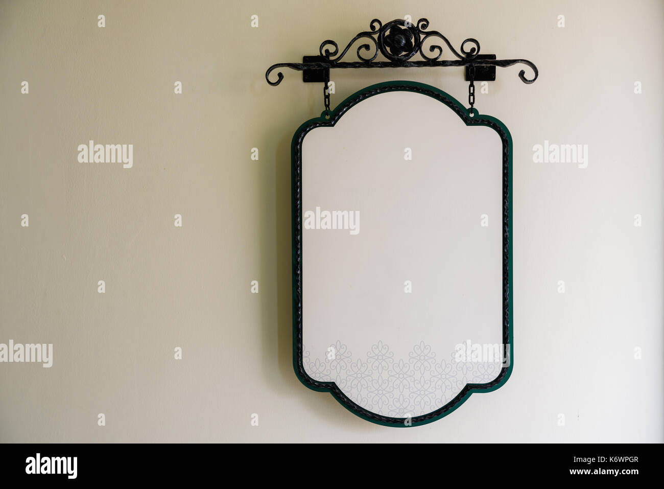 Blank hanging white iron plate sign with floral pattern attached on ...