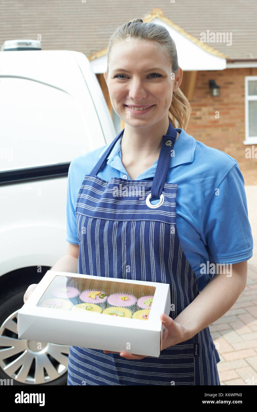 Female Baker Standing Next To Van Making Home Delivery Of Cupcakes ...