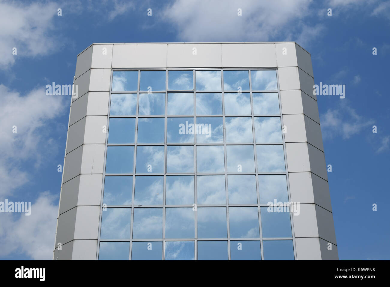 Blue sky and clouds reflected on modern glass building windows Stock ...