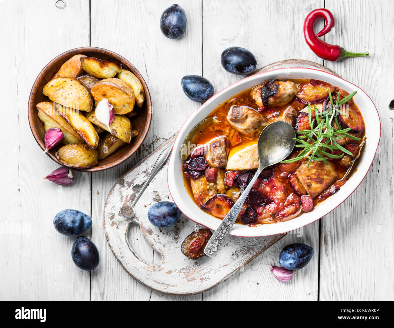 meat stew in sauce of autumn plums on a retro background Stock Photo ...