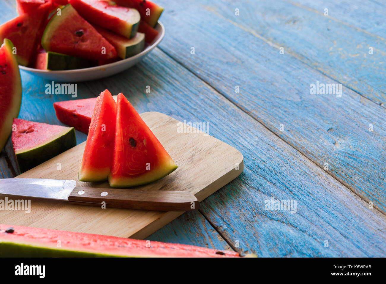 Watermelon slice popsicles on a blue rustic wood background Stock Photo ...