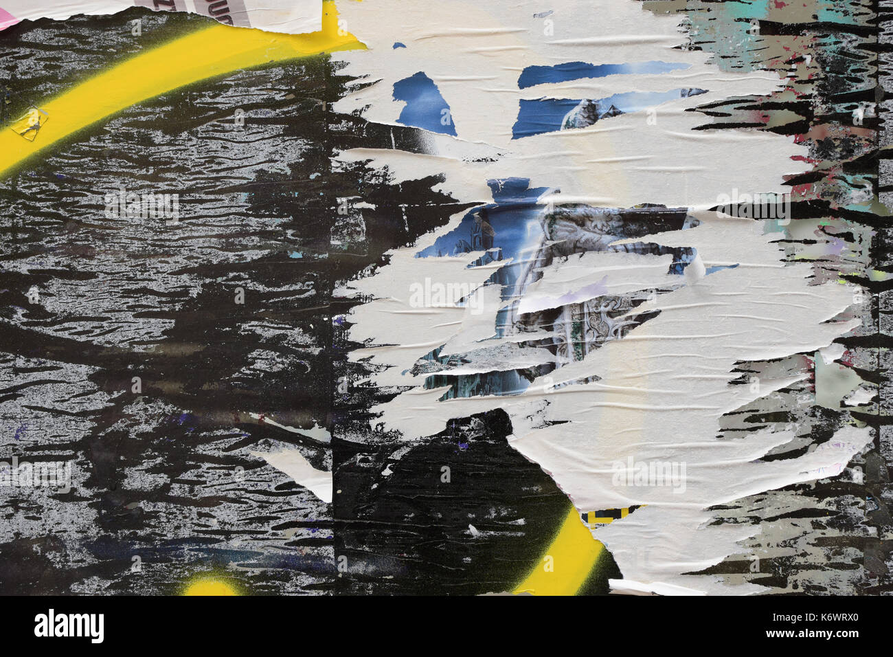 Torn paper posters glue and paint stains on messy storefront glass of ...