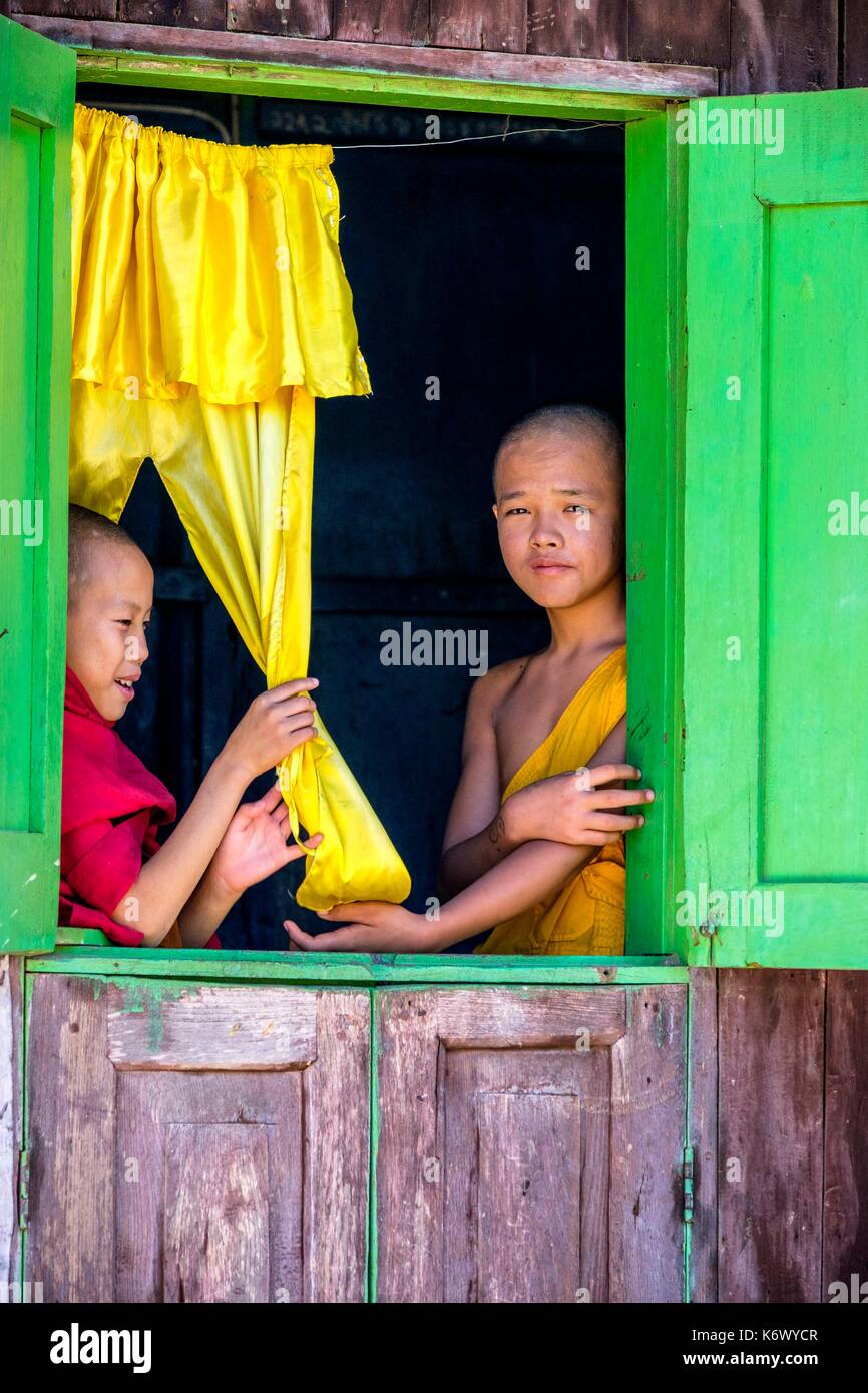 Myanmar (Burma), Shan state, Hsipaw, young monks looking out the window ...