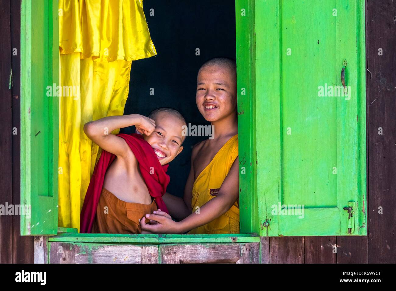 Myanmar (Burma), Shan state, Hsipaw, young monks looking out the window ...