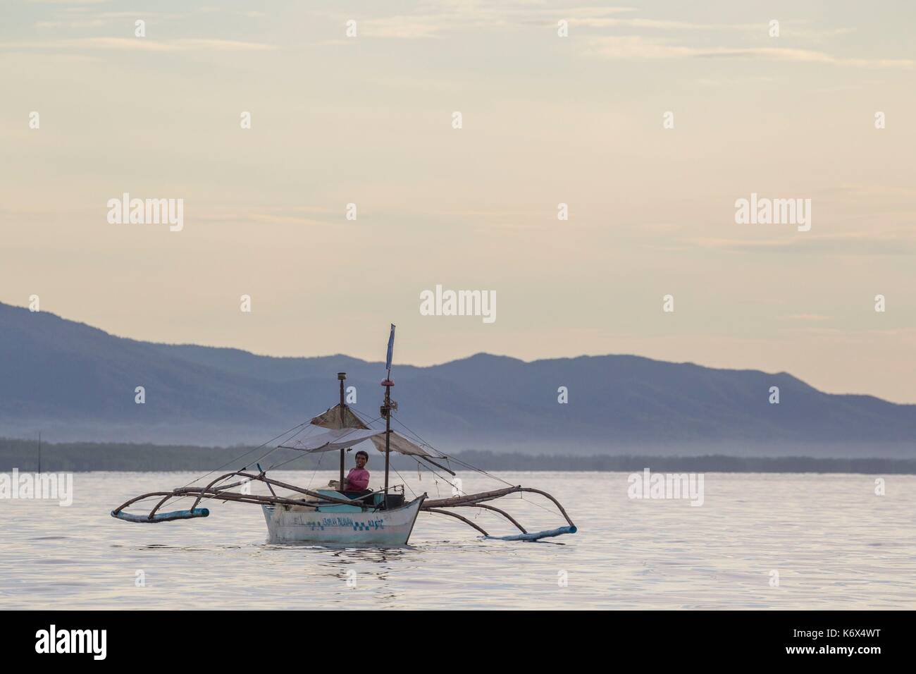 Philippines, Palawan, Aborlan, Sombrero Island, fisherman on his boat ...