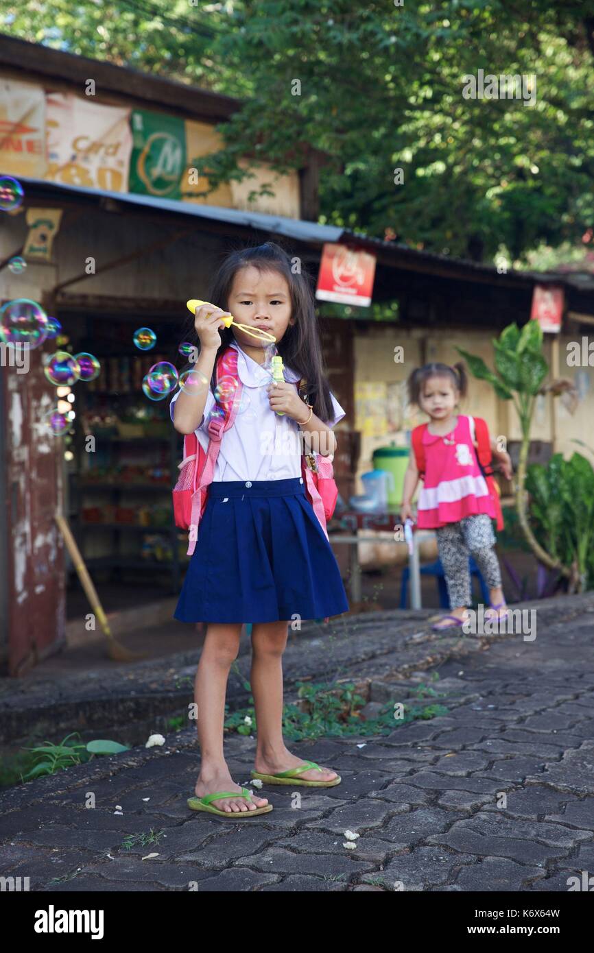 Laos, Vientiane, schoolgirl uniform making soap bubbles Stock Photo - Alamy