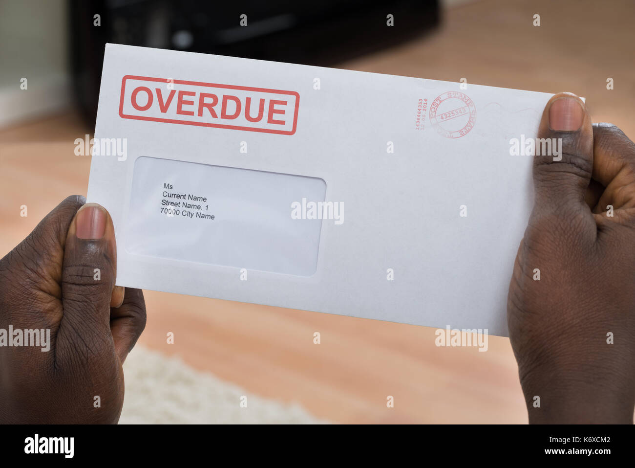 Close-up Of Person's Hand Holding Overdue Notice Stock Photo - Alamy