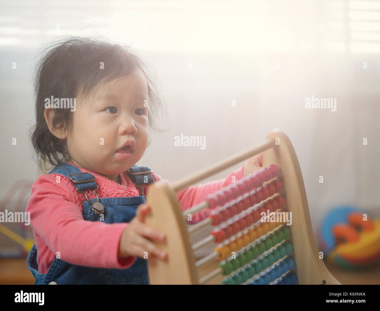 cute baby girl play toy at home Stock Photo - Alamy