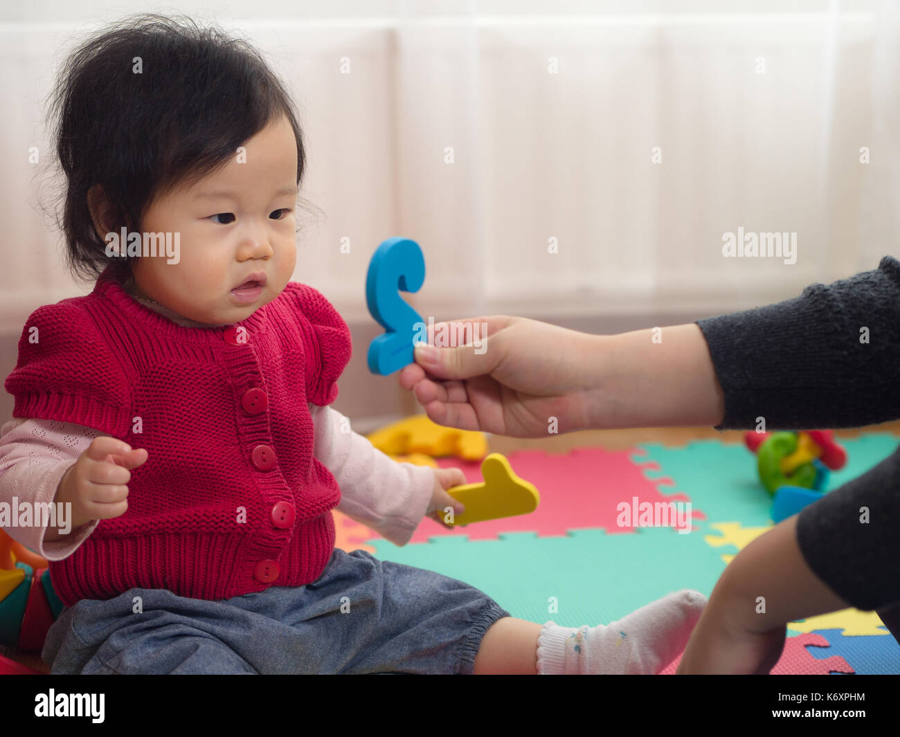 baby girl learning letters Stock Photo - Alamy