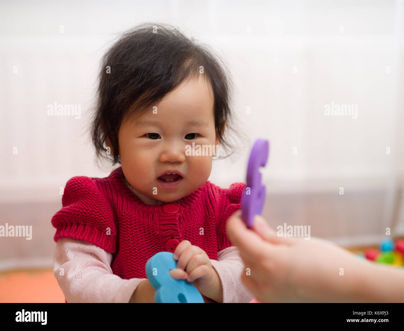 baby girl learning letters Stock Photo - Alamy