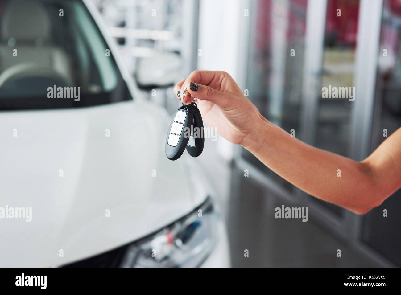 Passing car keys. Cropped closeup of a car dealer holding out car keys ...