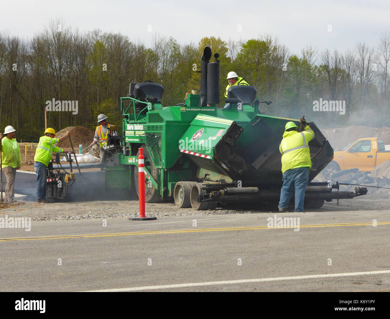 Crew laying asphalt using a paver Stock Photo - Alamy