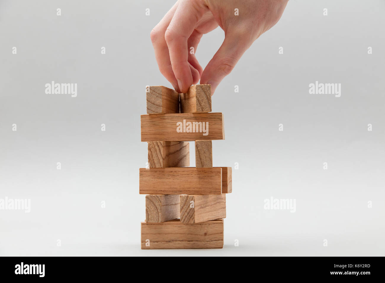 Male hand stacking wooden hi-res stock photography and images - Alamy