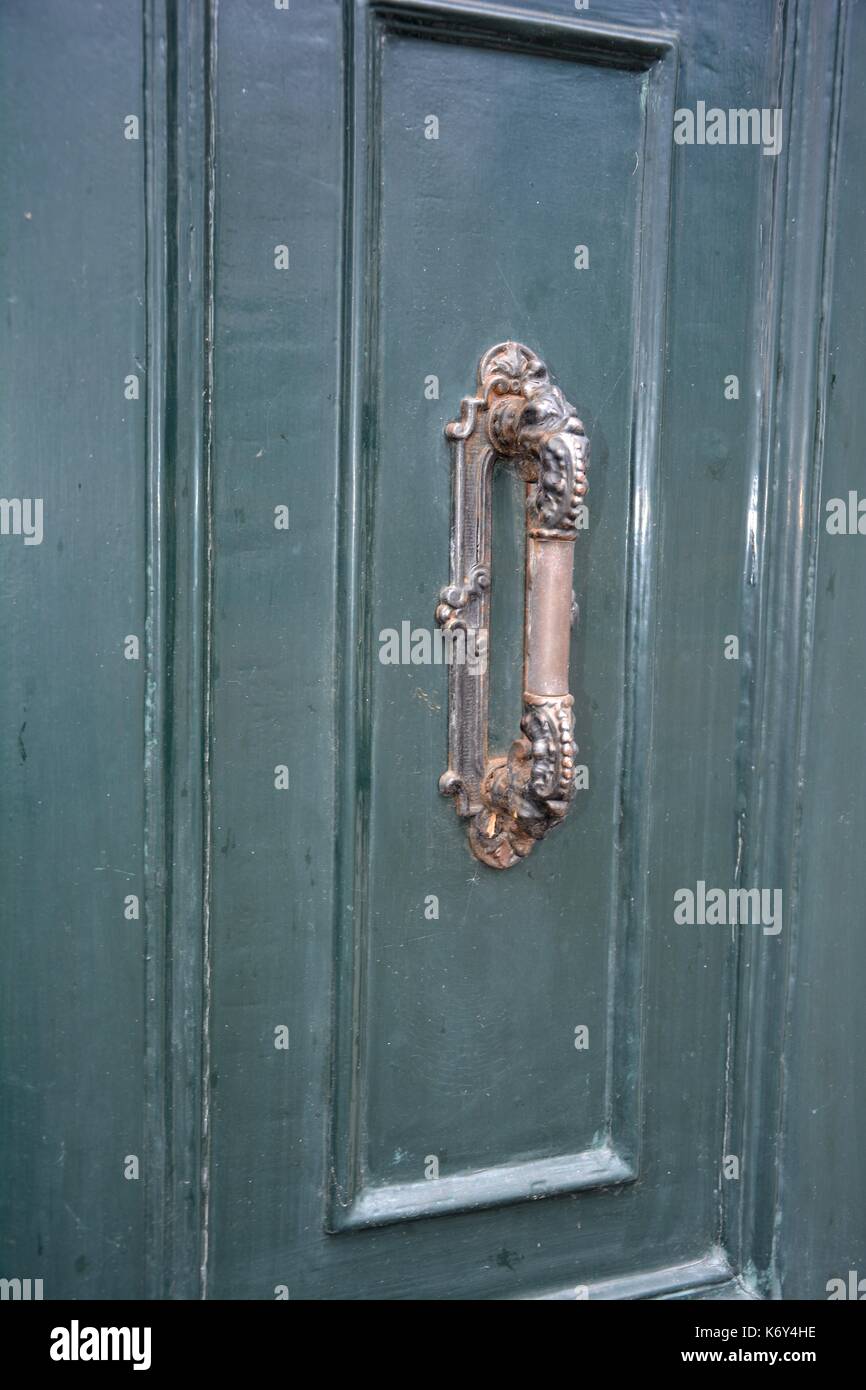 Detail of an old door of the side with antique metal clutch in the ...