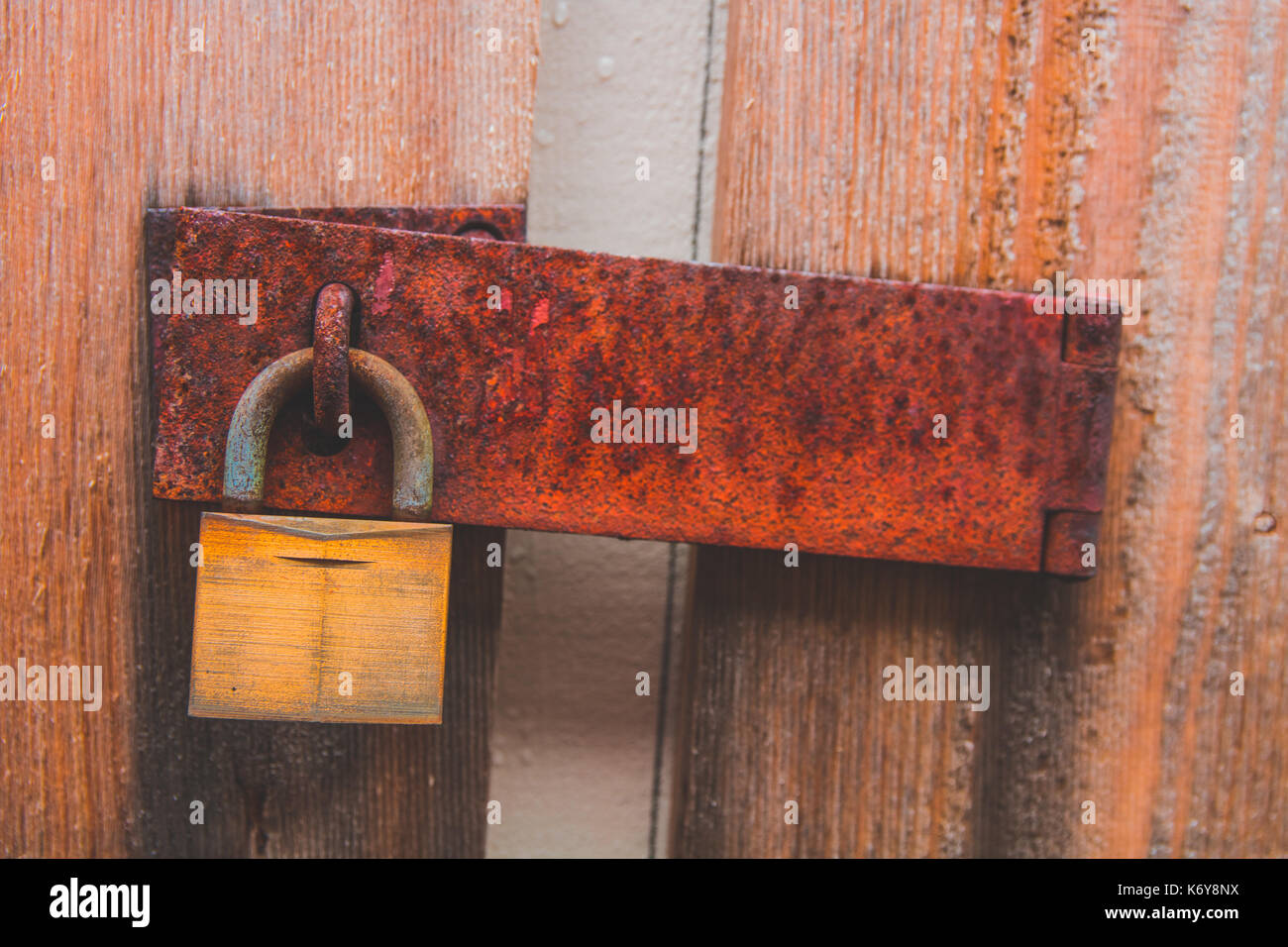 Rusty padlock on wooden door Stock Photo - Alamy