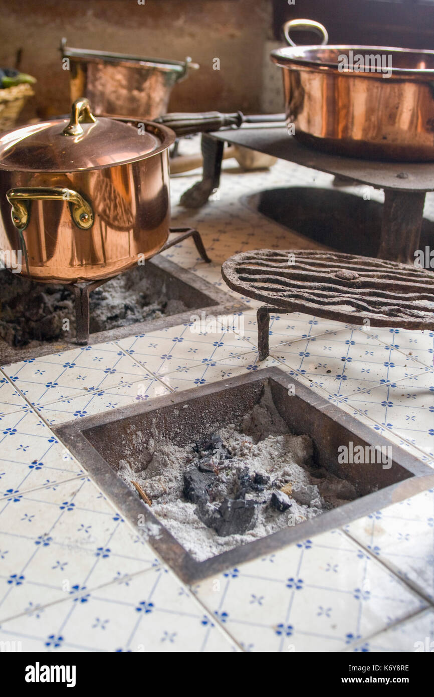 copper pans and small coals burning in a 17th century kitchen Stock ...