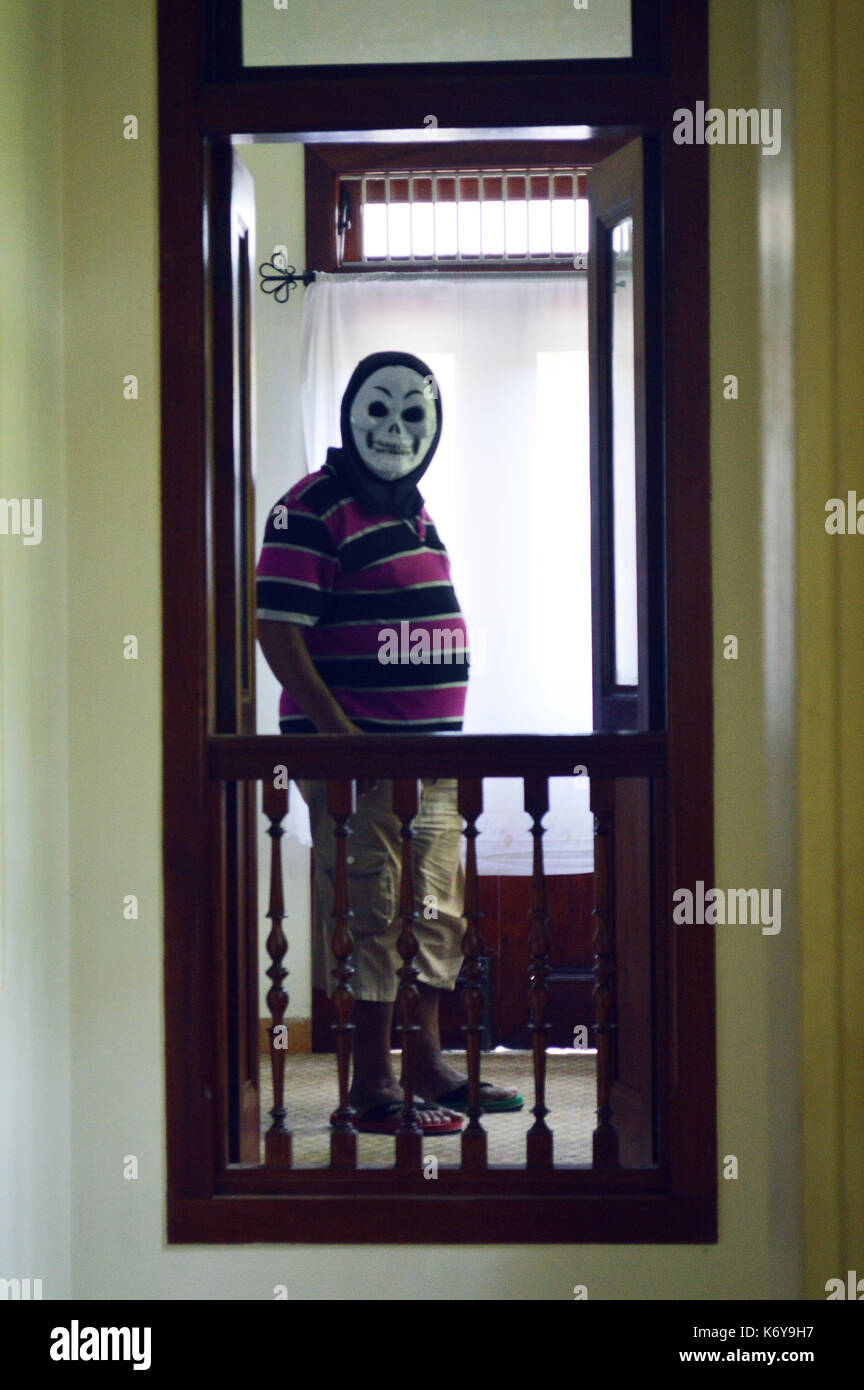 Man masking in house interior Stock Photo - Alamy