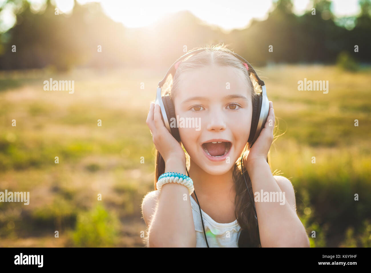 beautiful girl listening music with headphones and singing Stock Photo ...