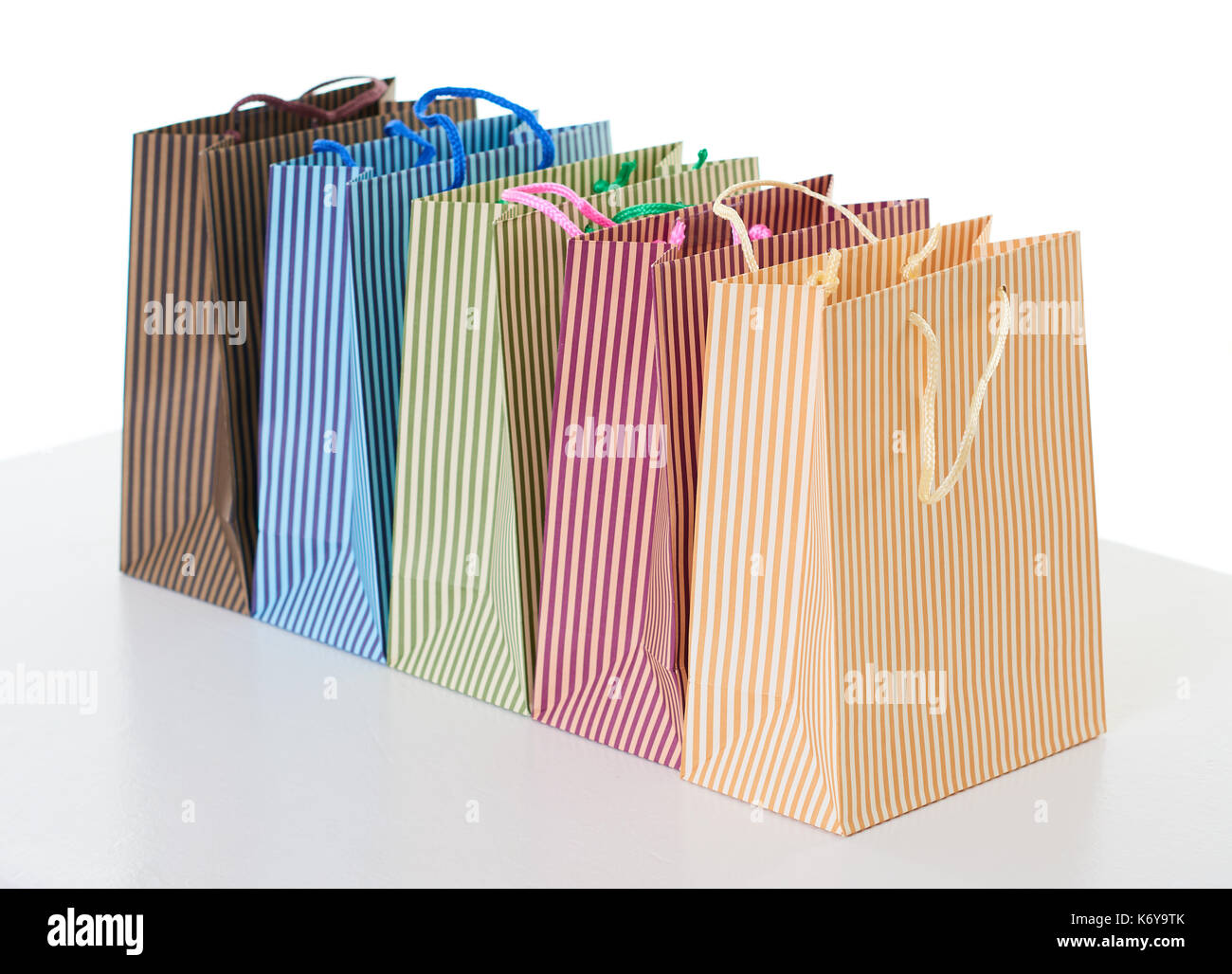 colorful striped shopping bags arranged in a row, object isolated on ...